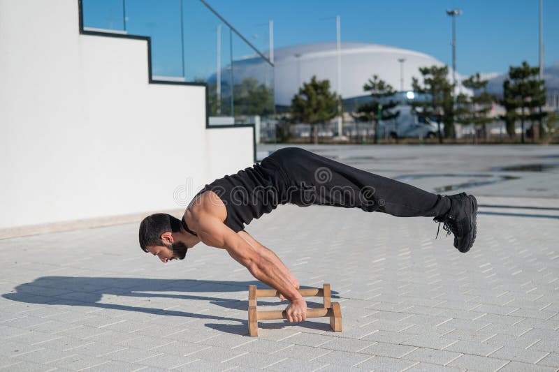 Man Doing Balance Exercise on Floor Bars for Fitness. Stock Photo ...