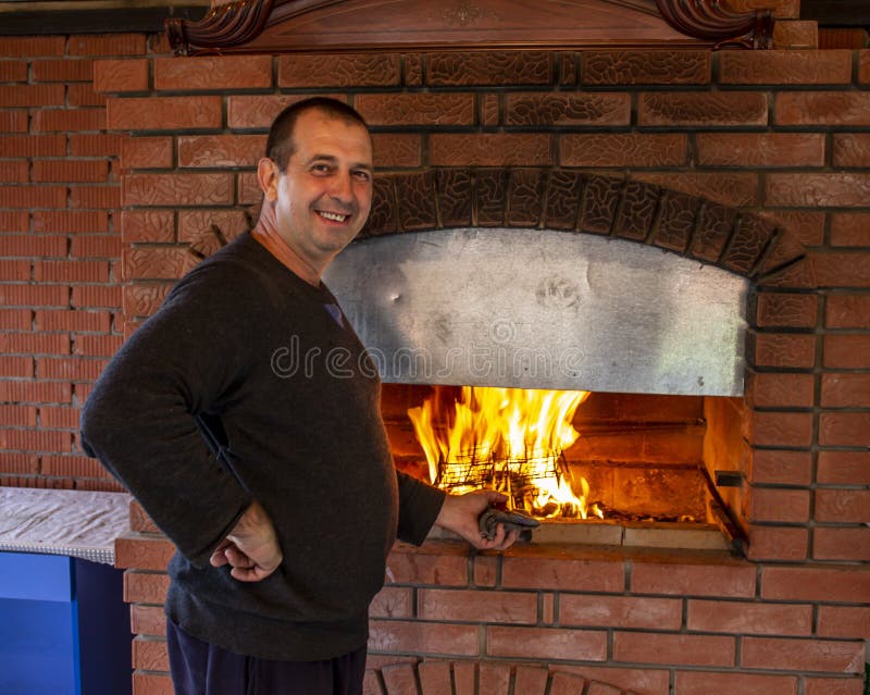 Man Doing Barbecue, Grilling Kebabs on the Fire in the Oven Stock Photo ...