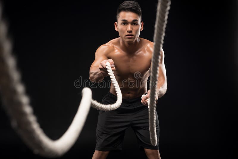 Man Doing Battle Ropes Exercise Stock Photo - Image of young, isolated ...