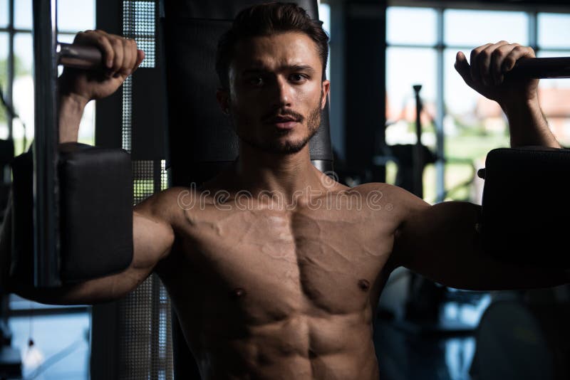 Man Doing Butterfly Chest Exercise on Machine Stock Image - Image of ...