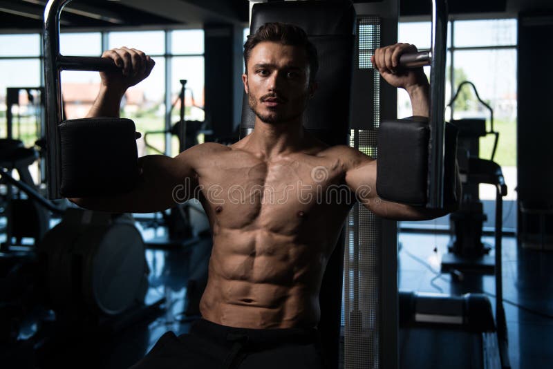 Man Doing Butterfly Chest Exercise on Machine Stock Photo - Image of ...