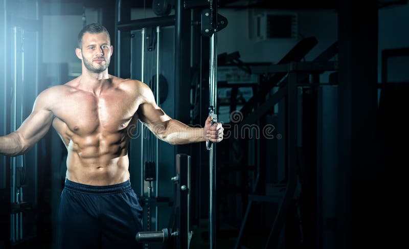 Muscular Man in Gym Showing Biceps Muscles. Strong Male Stock Photo ...