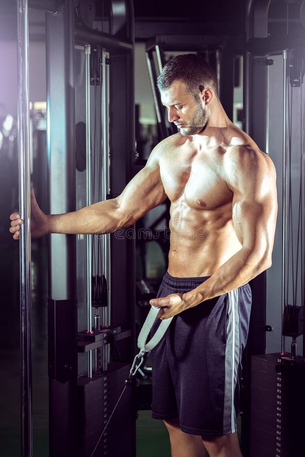 Man doing cable fly in gym stock image. Image of hand - 59429871