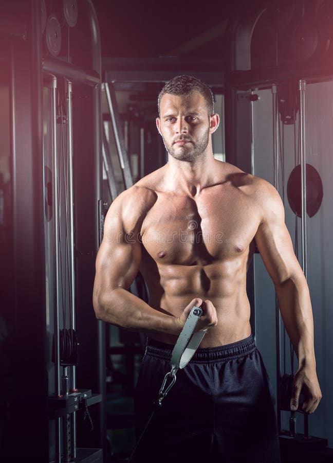 Man doing cable fly in gym stock image. Image of biceps - 68765573