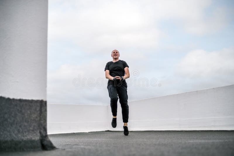 A Man Doing Cardio Exercises on the Rooftop during Lockdown Stock Photo ...
