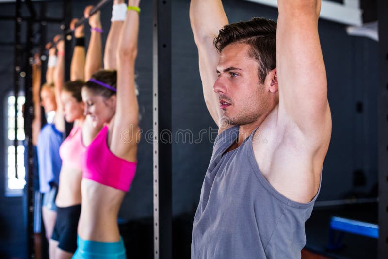 Man doing chin-ups in gym stock image. Image of sports - 78629121