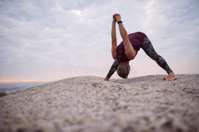 Man Doing the Clasp Hands Forward Fold Pose Outdoors Stock Image ...