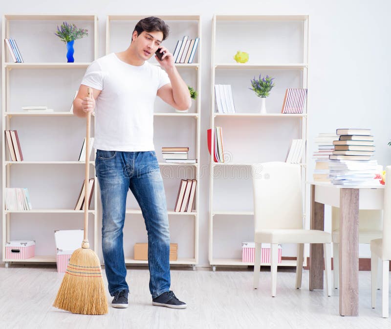Man doing cleaning at home stock photo. Image of dusting - 195129388