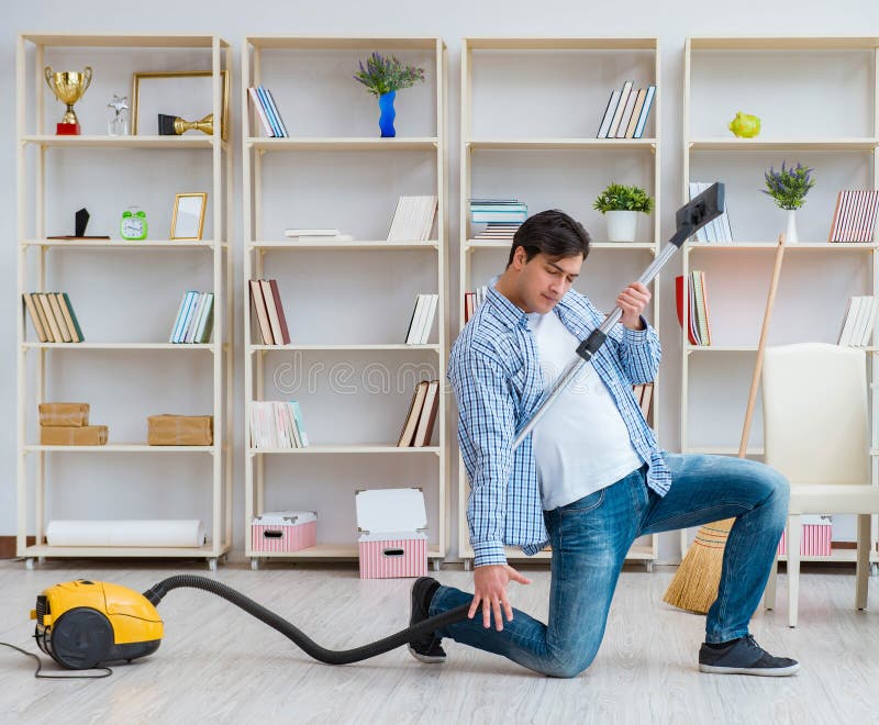 Man doing cleaning at home stock image. Image of furniture - 197628545