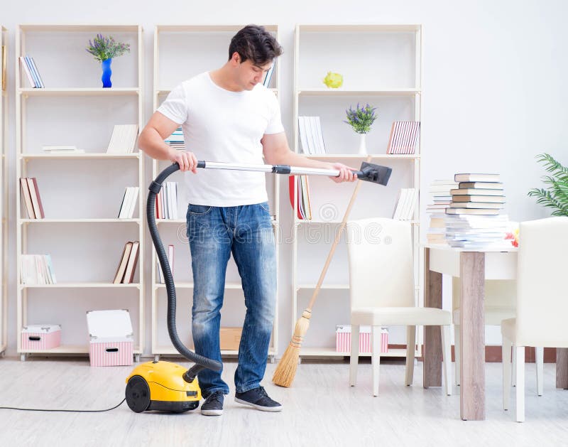 Man doing cleaning at home stock photo. Image of broomstick - 202626860