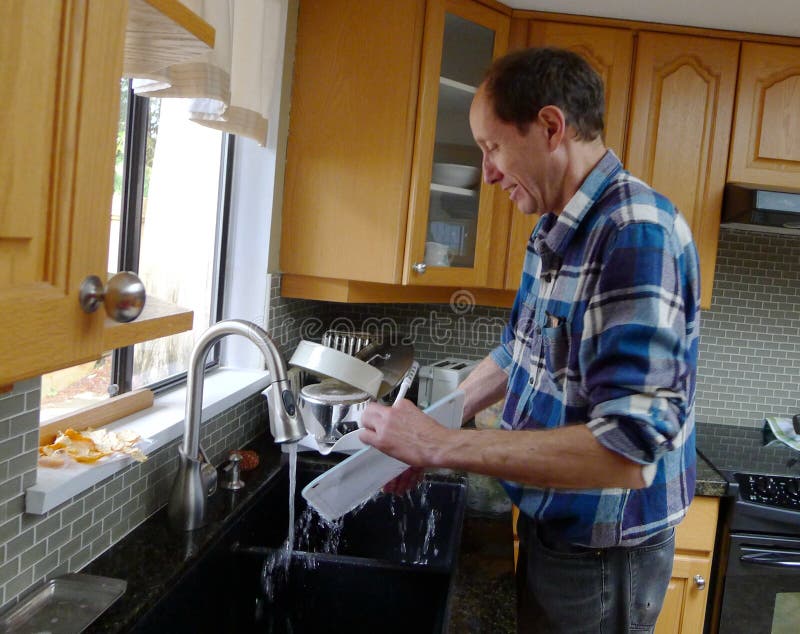 Man Doing Cleaning Work in the Kitchen Stock Photo - Image of shirt ...