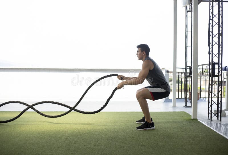 Squat Exercises with Rope in the Gym Stock Image - Image of equipment ...