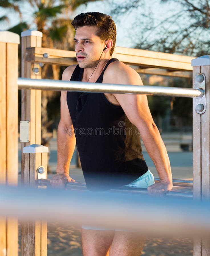 Man Doing Dips on Horizontal Bars Outdoors Stock Image - Image of ...