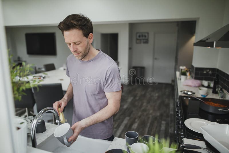 Man Doing Dishes at Home stock image. Image of culture - 98856495