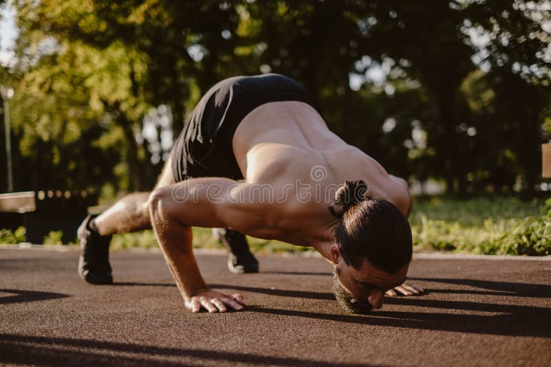 Man Doing Dive Bomber Push Ups Outdoor with Face Down Stock Image ...