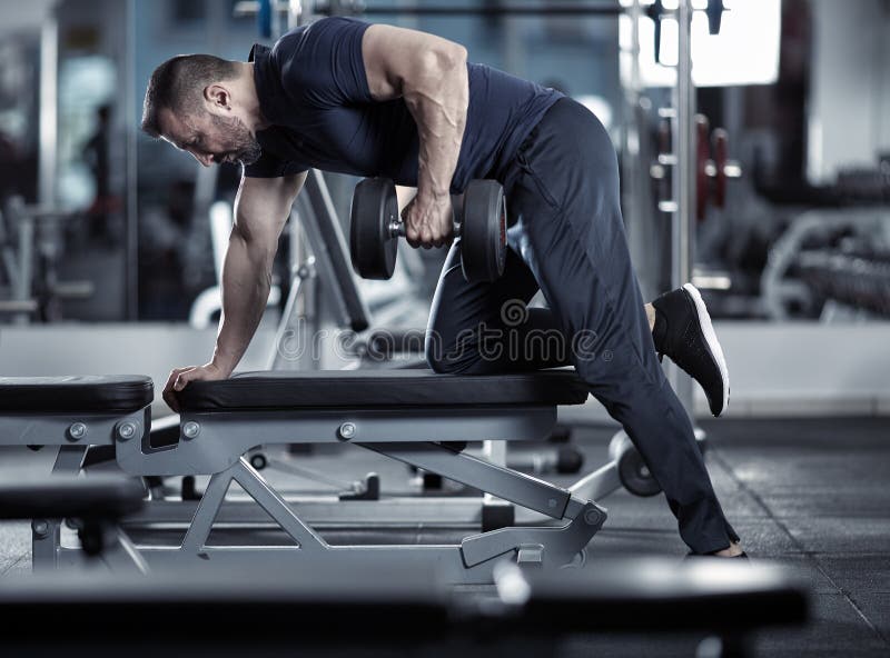 Man doing dumbbell row stock photo. Image of health, dorsal - 95411078