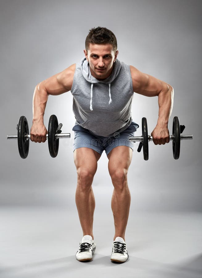 Dumbbell row in the gym stock photo. Image of body, lifting - 71428202