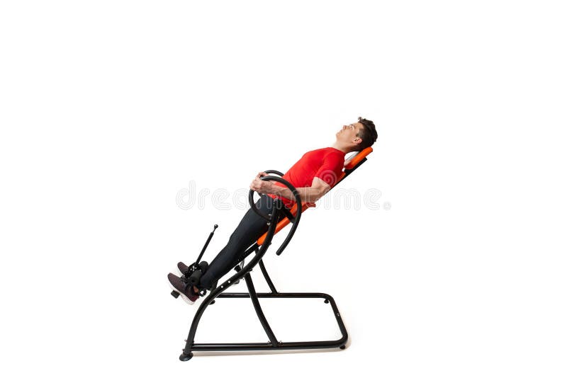 Man Doing Exercise on Inversion Table for His Back Pain, Isolated on ...