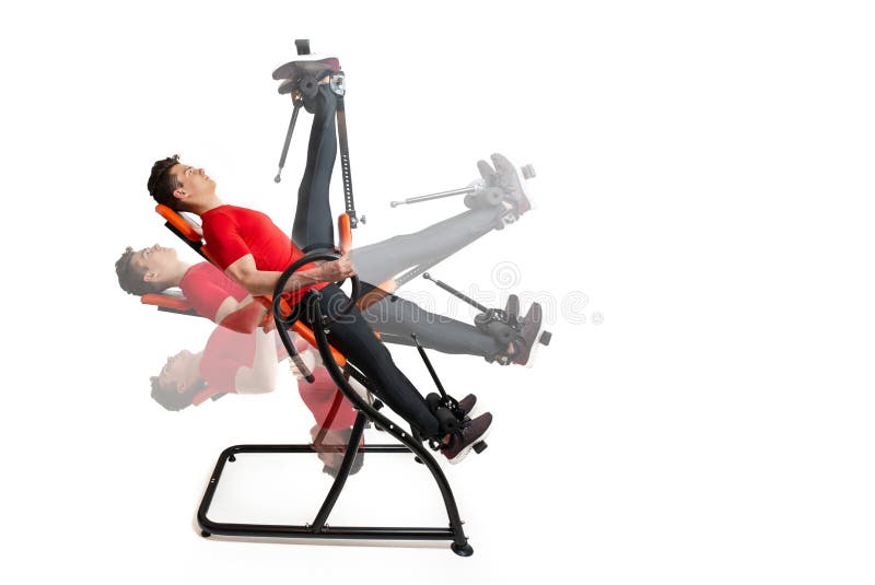Man Doing Exercise on Inversion Table for His Back Pain, Isolated on ...
