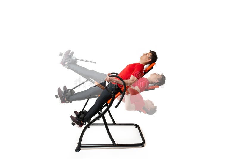 Man Doing Exercise on Inversion Table for His Back Pain, Isolated on ...