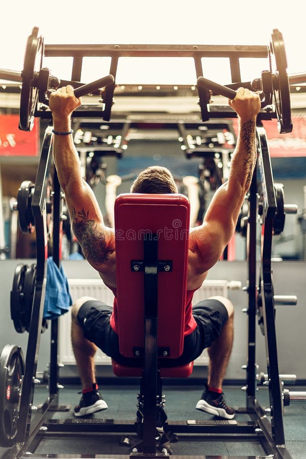 Man Doing an Exercise for the Shoulders in the Simulator Stock Photo ...