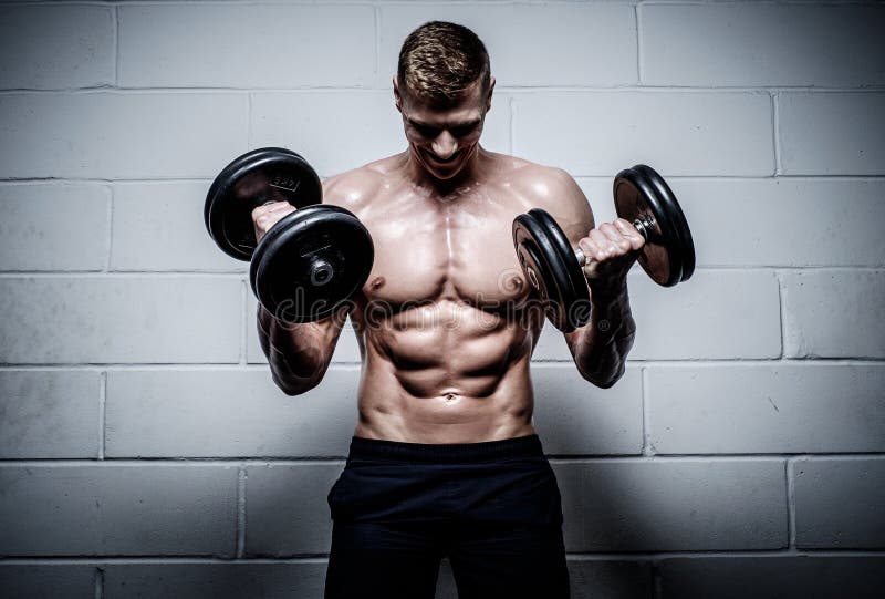 Man Doing Exercises with Dumbbells in the Gym S Studio Stock Image ...