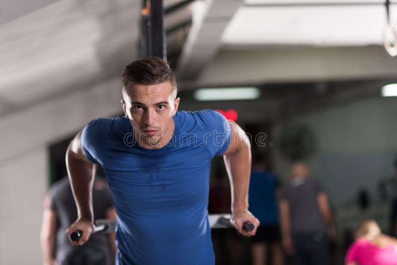 Man Doing Exercises Parallel Bars Stock Image - Image of adult, lifting ...