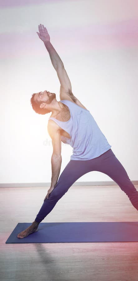 Man Doing Extended Triangle Pose Stock Image - Image of fitness ...