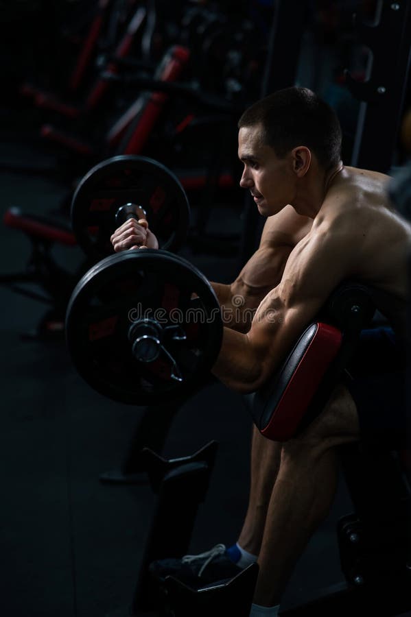 Man Doing EZ Barbell Bicep Exercises on Scott Bench. Stock Image ...