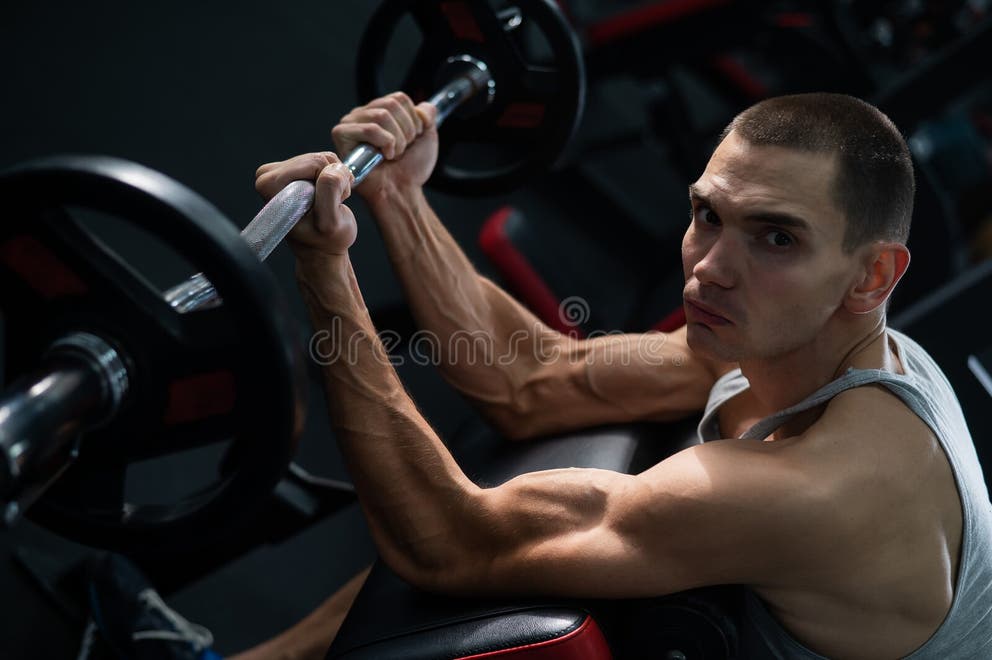 Man Doing EZ Barbell Bicep Exercises on Scott Bench. Stock Image ...