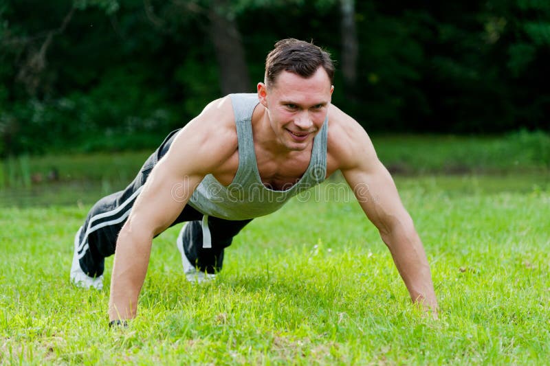 Man Doing Fitness Exercise on the Grass Stock Image - Image of park ...