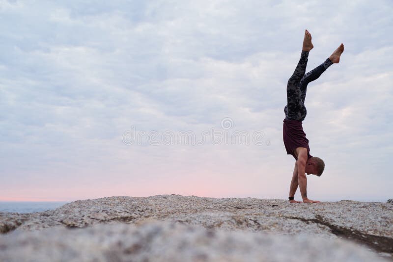 Man Doing a Hand Stand while Practicing Yoga at Dusk Stock Photo ...