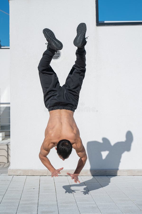 Shirtless Man Walks on His Hands Outdoors. View from Above. Stock Image ...
