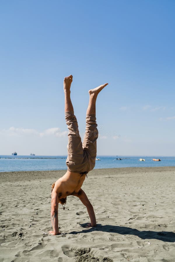 Man Doing Handstand for Strength and Balance on Sandy Beach Stock Image ...
