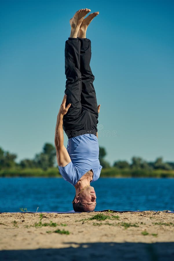 Man doing a headstand stock photo. Image of aerobics - 98157892
