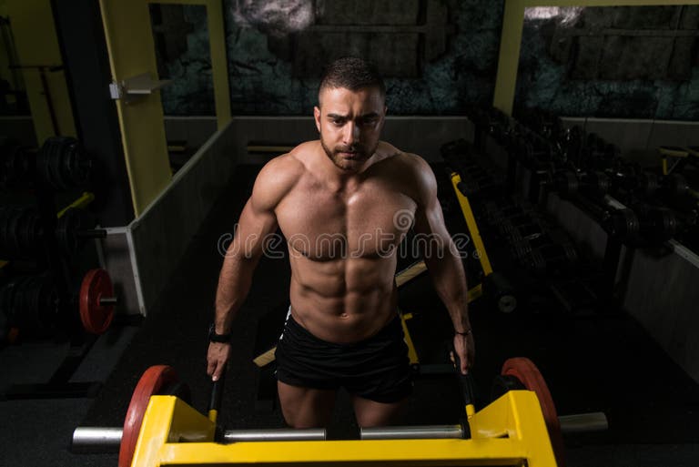 Man Doing Heavy Weight Exercise for Trapezius Stock Photo - Image of ...