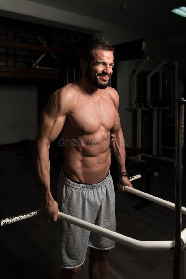 Man Doing Heavy Weight Exercise for Trapezius Stock Photo - Image of ...