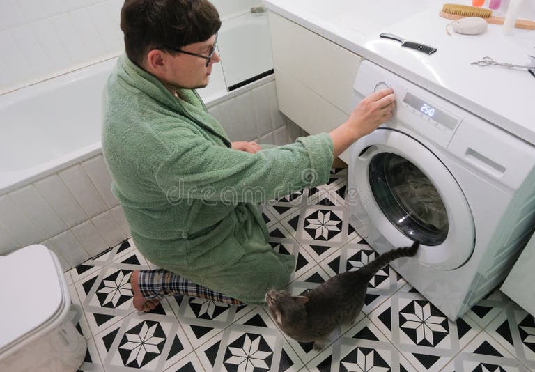 Man Doing Laundry in the Bathroom Loading Washer Stock Photo - Image of ...