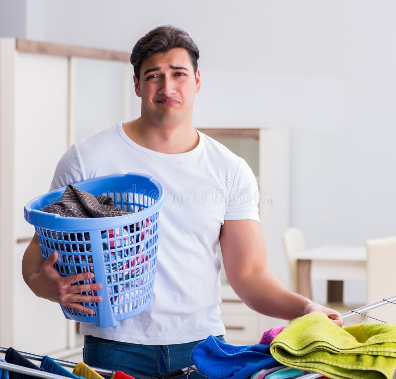 Man doing laundry at home stock image. Image of clothes - 260917891