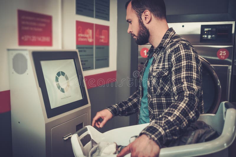 Man Doing Laundry at Laundromat Shop. Stock Photo - Image of casual ...