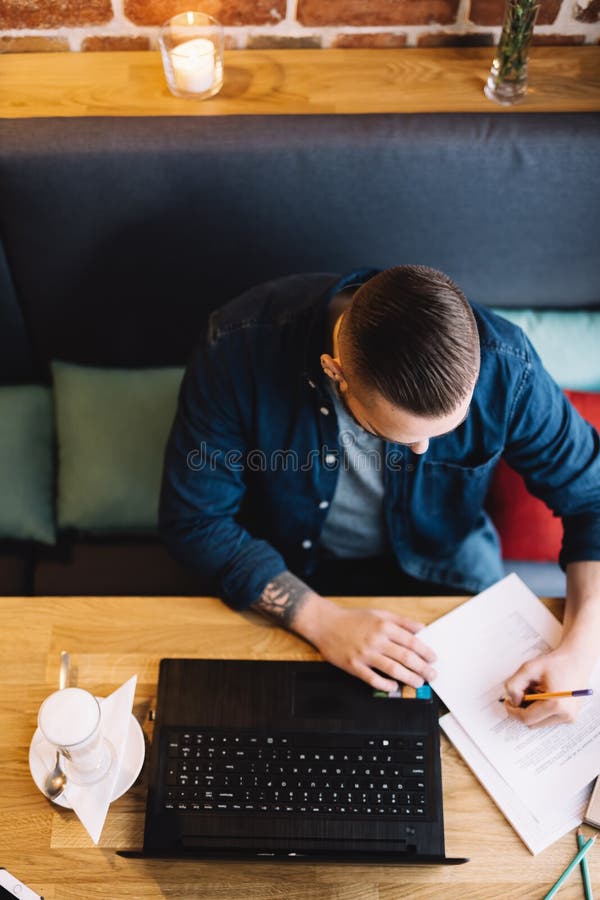 Man Doing Paperwork in a Cafe. Stock Image - Image of concentration ...