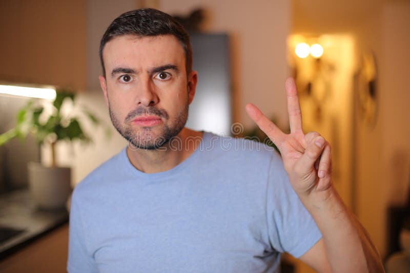 Man Doing the Peace Sign Gesture with One Hand Stock Photo - Image of ...