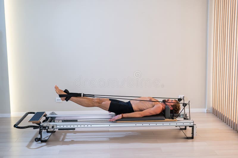 A Man Doing Pilates on a Reformer. Stock Image - Image of equipment ...