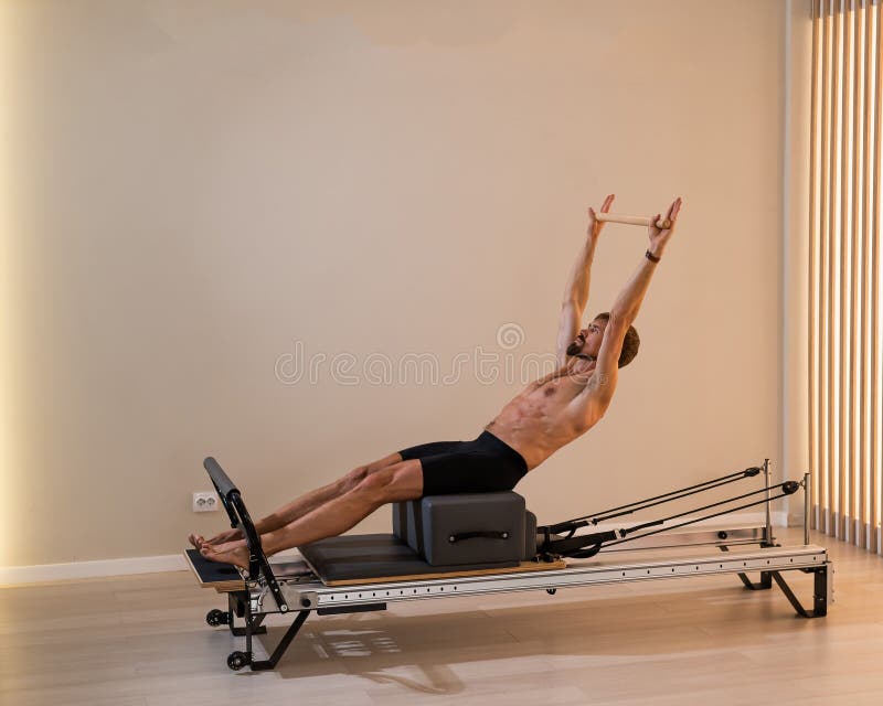 A Man Doing Pilates on a Reformer. Stock Image - Image of body, machine ...