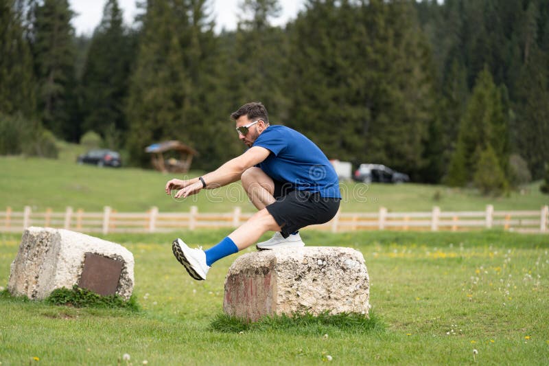 Man Doing Pistol Squat on a Big Rock Stock Photo - Image of strength ...