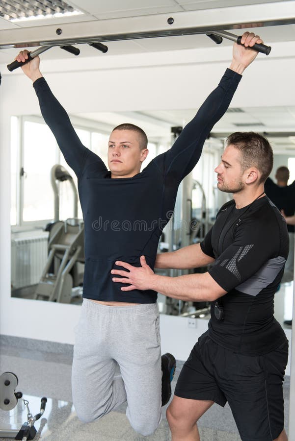 Man Doing Pull-Ups Exercises with Personal Trainer Stock Image - Image ...