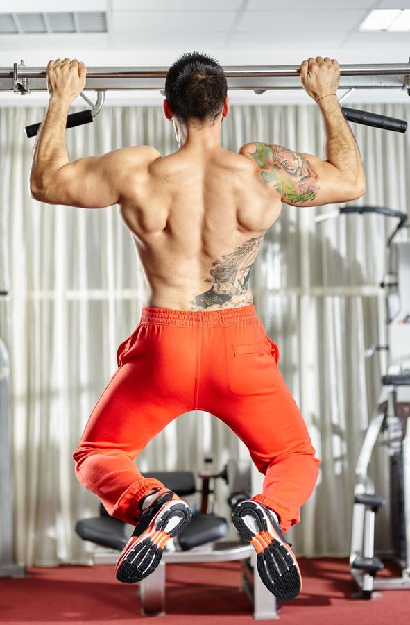 Man doing pull-ups stock photo. Image of masculine, back - 48602934