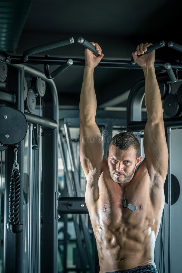 Man doing pull ups in gym stock photo. Image of biceps - 55638490