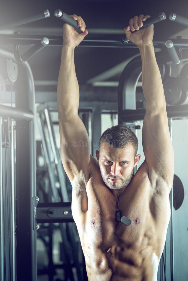 Man doing pull ups in gym stock photo. Image of biceps - 55638490