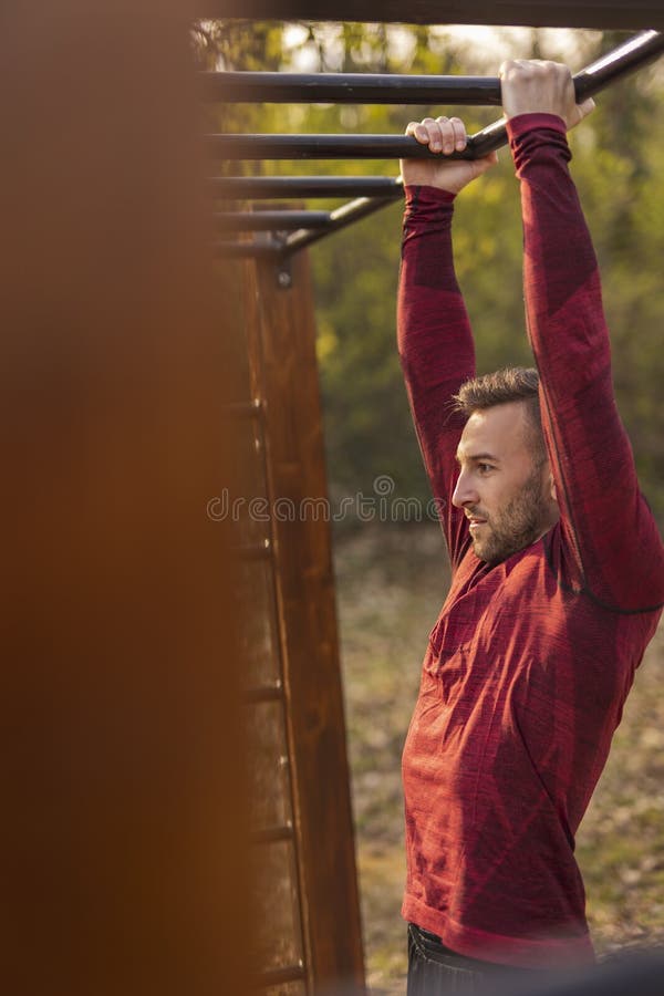 Man Doing Pull Ups while Working Out in Street Workout Park Stock Photo ...